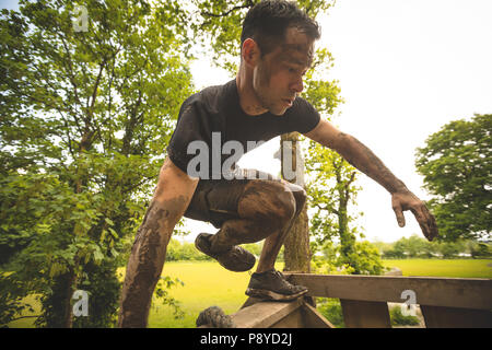 Fit man training over obstacle course Stock Photo - Alamy
