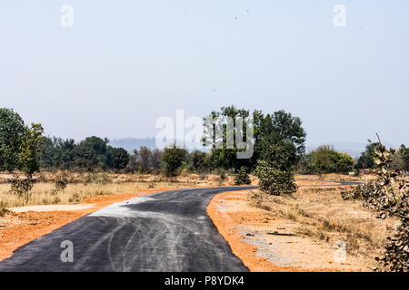Rural Indian uphill pitch road highway meets the sky horizon through ...