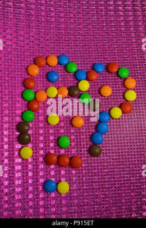 Matte sweets in the form of a crown, shivering candies of brown, blue ...