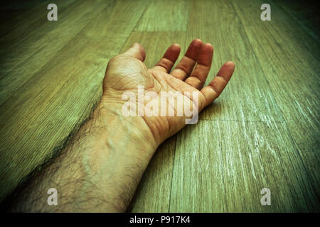 male hand and arm lying on the floor, dead Stock Photo - Alamy