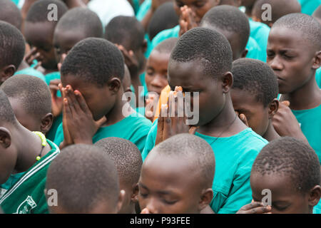 Bombo, Uganda - Praying students at the school appeal in the schoolyard ...
