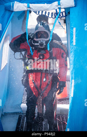 Coast Guard diver enters the water from a Coast Guard Cutter Healy ...