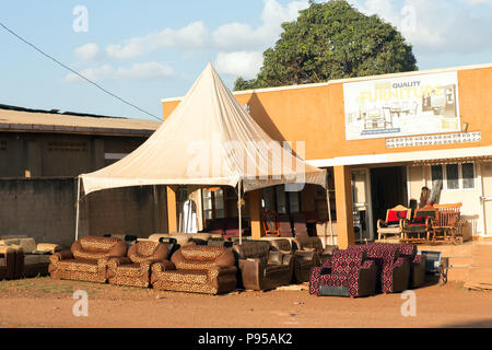 Wakiso Town, Uganda - Street scene. A customer buys paint in a hardware ...