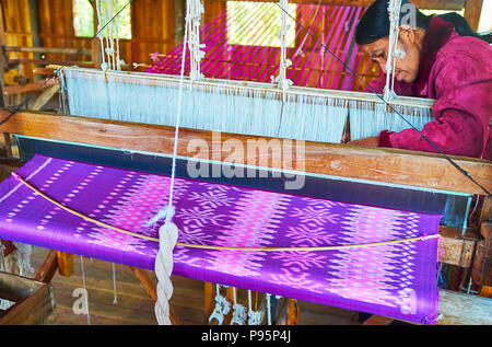 A burmese woman weaving lotus silk thread on a loom, In Paw Khone Stock ...