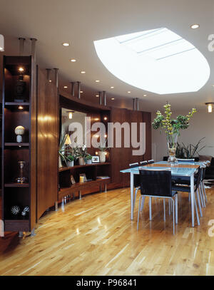 Curved storage unit dividing kitchen from dining room with wooden ...