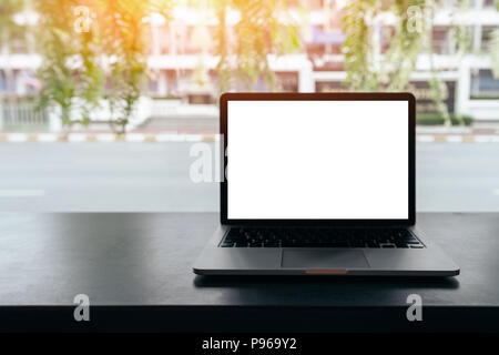 Conceptual workspace, Laptop computer with blank white screen on table ...