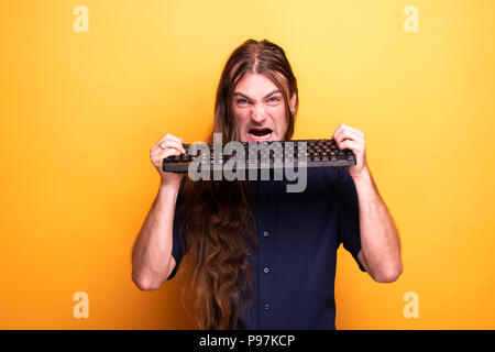 Crazy man eating a keyboard Stock Photo - Alamy