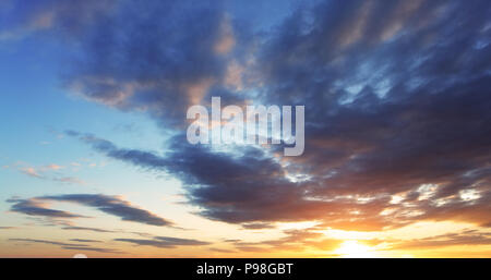 dramatic clouds on red sky over city roof tops at sunset Stock Photo ...