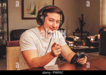 Gamer man pointing finger like it is challenging the spectator to play ...