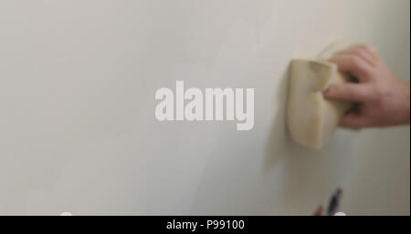 closeup worker applying protective finish on a wall, wide photo Stock ...