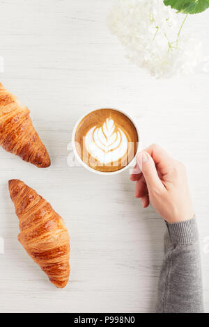 Closeup of a woman's hand holding a hydrangea bridal bouquet, in front ...