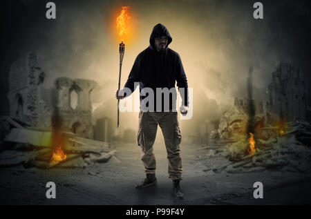 Destroyed place after a catastrophe with man in raincoat and lantern ...