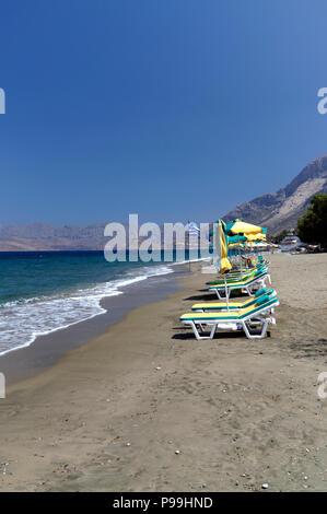 Bed chairs and sun shades, Masouri Beach, Kalymnos, Dodecanese islands ...