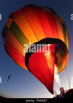 Hot Air Balloon getting inflated on the ground Stock Photo - Alamy