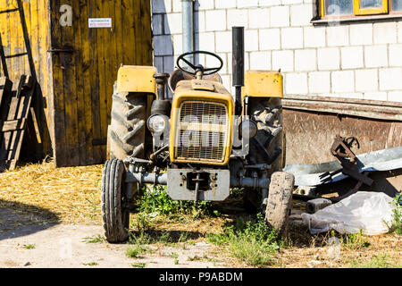 An old tractor produced in the 70s of the 20th century. Isolated photo ...