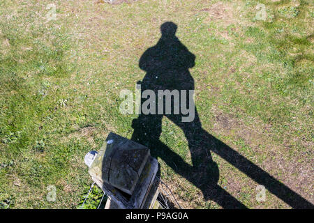 A high angle shot of a man with green painted hand against colorful ...
