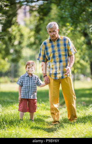Caucasian cute boy talking with grandfather in sign language while ...
