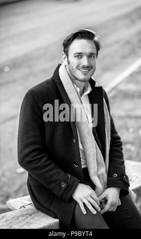 Handsome man wearing winter coat smiling with happy face looking and ...