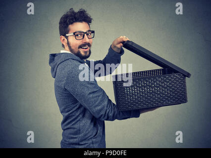 amazed cheerful hipster with beard holding coffee cup on yellow ...