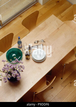 Aerial view of dining room table place settings with red tablecloth ...