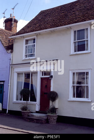 Clipped bay trees on either side of blue front door of Victorian house ...