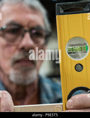 senior man using spirit level Stock Photo - Alamy