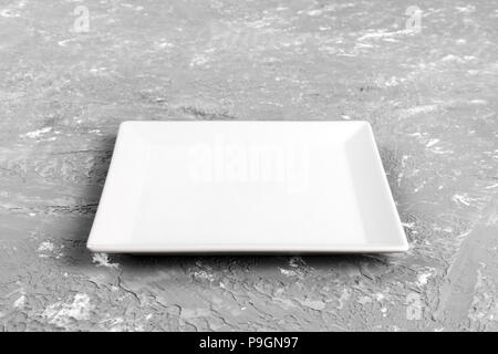 Perspective view of empty square plate on wooden background. Empty ...