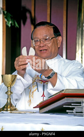 Communion priest breaking host wafer communion MR © Myrleen Pearson ...
