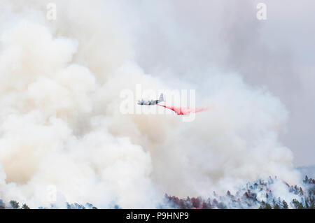 An aircraft drops slurry to support fire suppression efforts July 4 ...