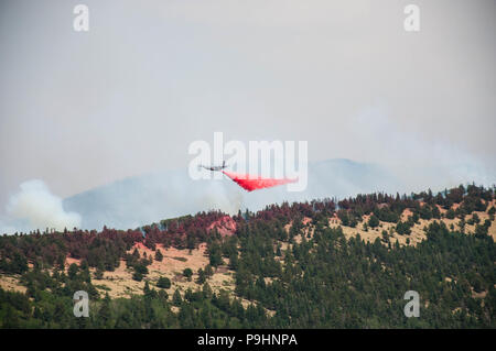 An aircraft drops slurry to support fire suppression efforts July 4 ...
