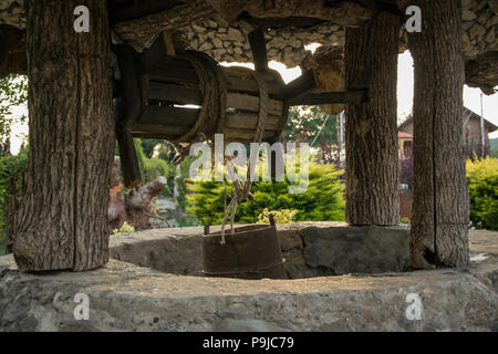 Old traditional stone wishing well situated in hotel grounds, Kawama ...