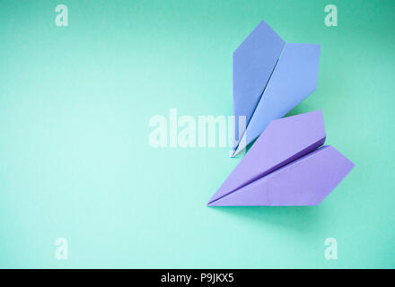 Paper planes on pink and blue background Stock Photo - Alamy