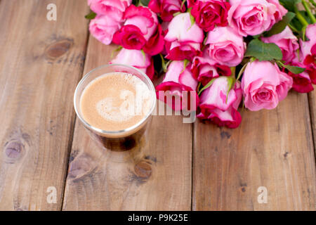 Bouquet of pink roses, coffee, blank paper and other objects on white ...
