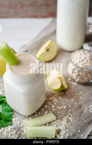 Smoothies of oatmeal and celery on wooden background. The concept of ...