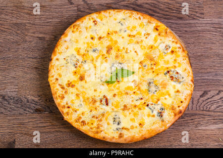 Four cheese pizza served basil Stock Photo - Alamy
