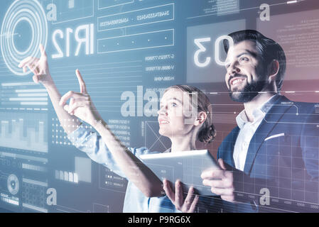 Emotional programmer smiling while working with new technologies Stock ...