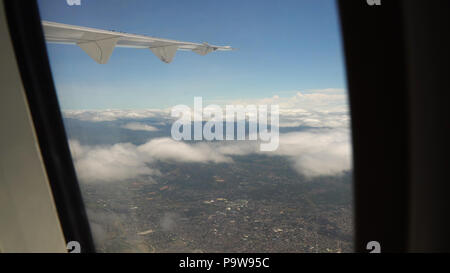 A view of the city of Manila through the window from the plane ...