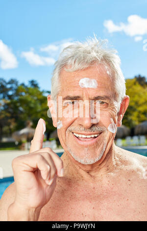 Old man, smile and face with oil for skincare, beauty and grooming, apply facial serum on studio ...