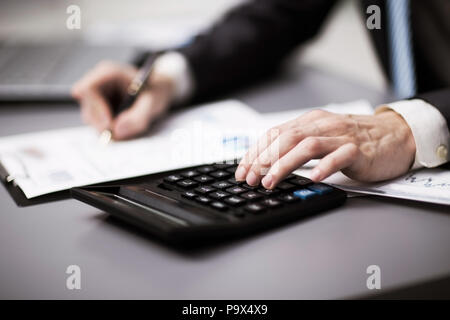 financial adviser working with calculator, business document at office ...