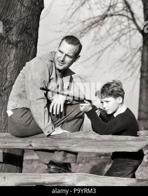 Father teaching his son about gun safety and proper use on hunting in ...