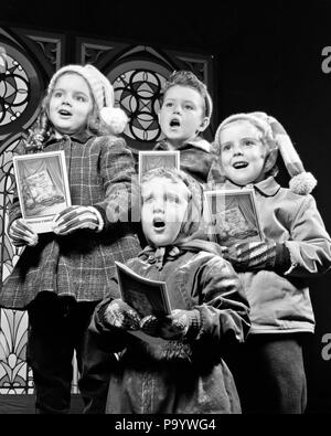 child singing Christmas carol at Christmas Stock Photo - Alamy