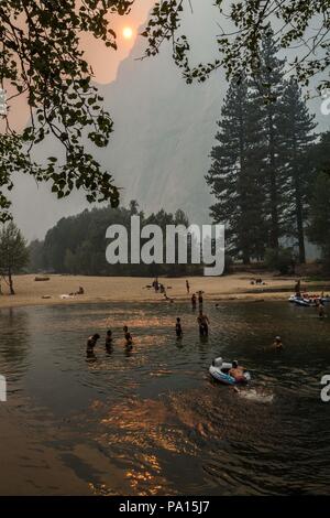 Tourists swimming in the Merced River in Yosemite National Park ...