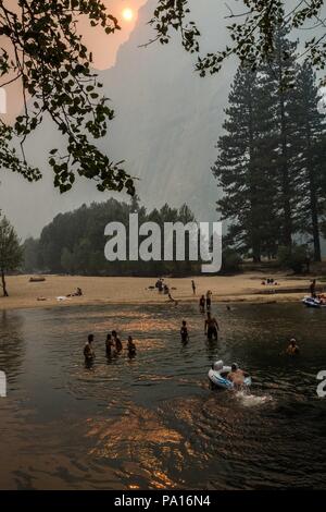 Tourists swimming in the Merced River in Yosemite National Park ...