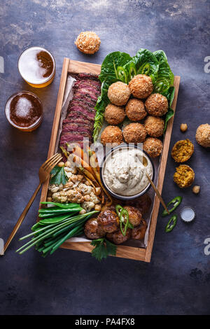 Middle eastern party food: falafel, babaghanoush, potatoes beef green ...