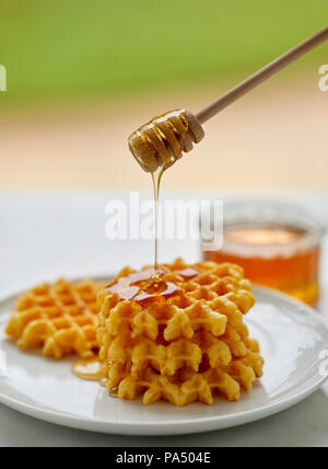 Honey in jar with honey dipper on a wooden background Stock Photo - Alamy