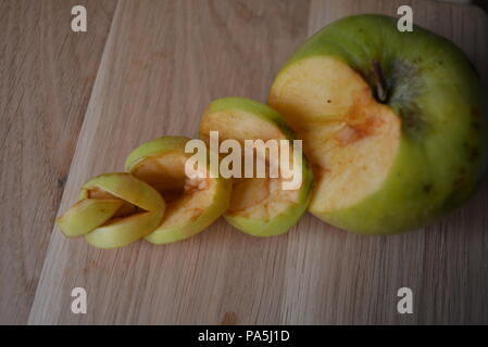 Fresh green apple with slices of apple and apple slide on a light ...