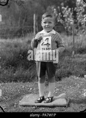 15 Albert Percy Godber's grandson Colin, seated beneath a carved sign ...