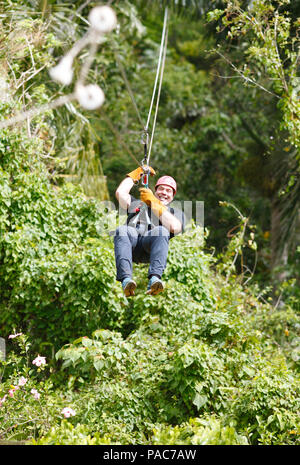 Riding on a zip line Stock Photo - Alamy