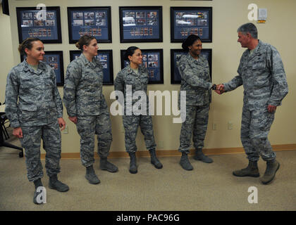 Lt. Gen. Sam Cox, commander of the 18th Air Force, greets Airmen as he ...