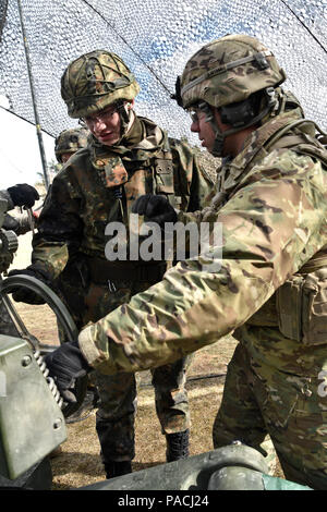 Spc. Julio Guerra (right,) a cannon crewmember assigned to Archer ...